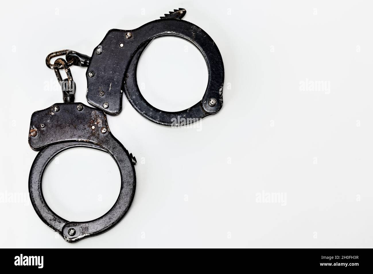 Old and rusty handcuffs Stock Photo - Alamy