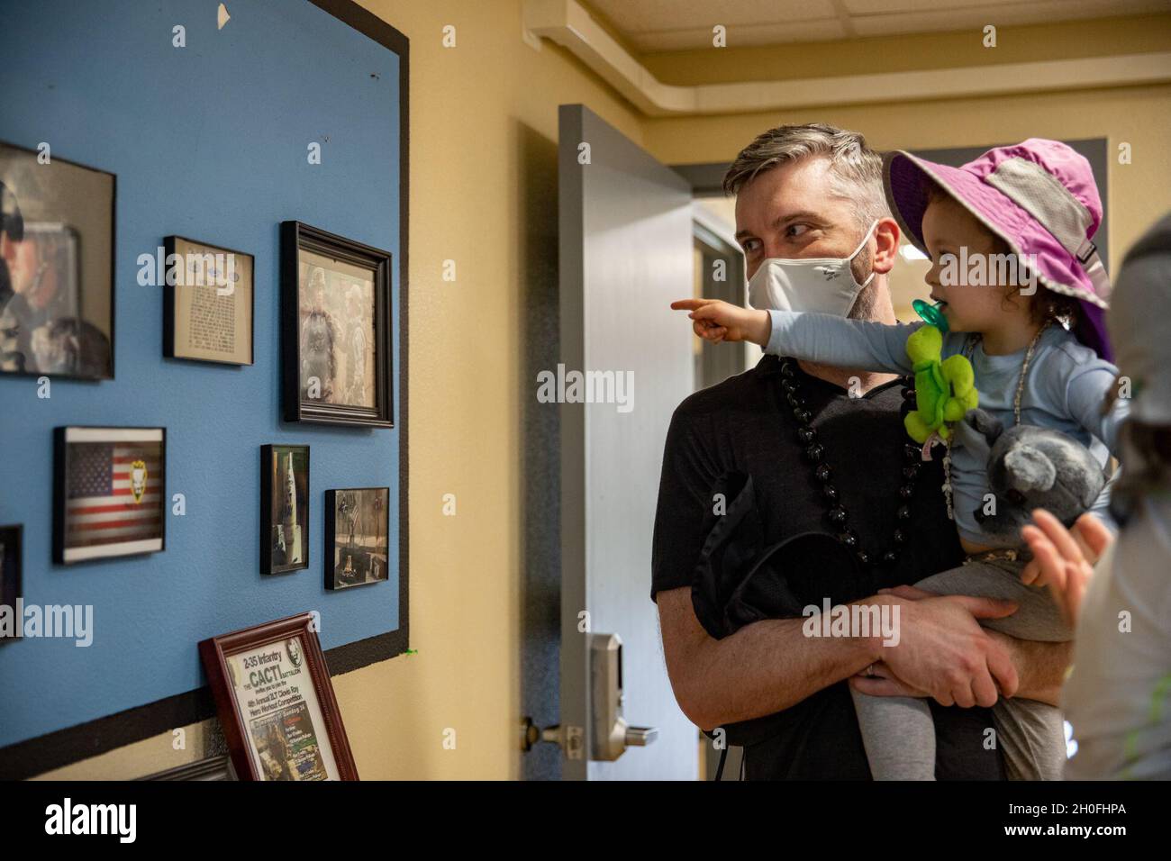 The child of Gold Star Family Member, Mrs. Jennifer Ray, points at her ...