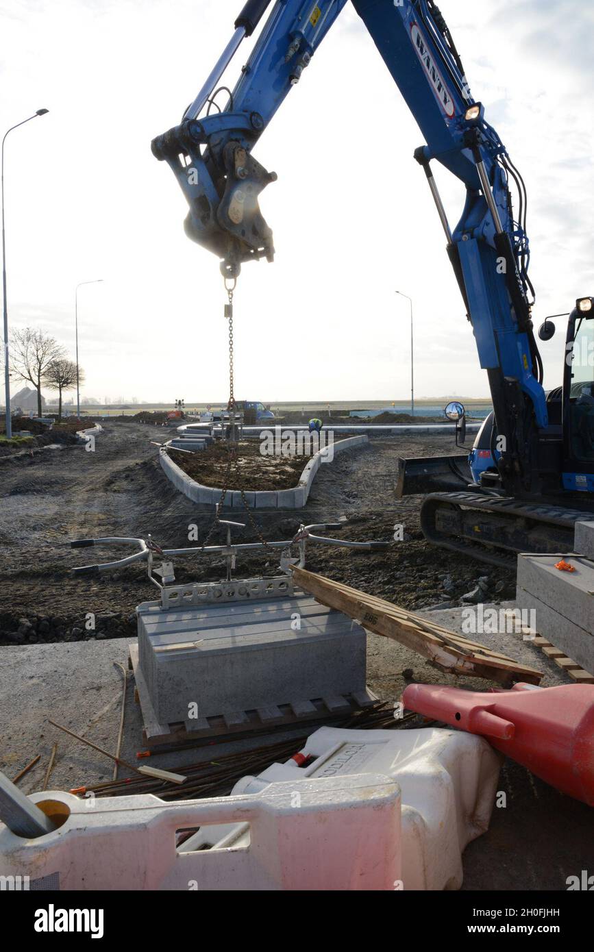 A contractor with Belgian construction firm WANTY lifts a concrete ...