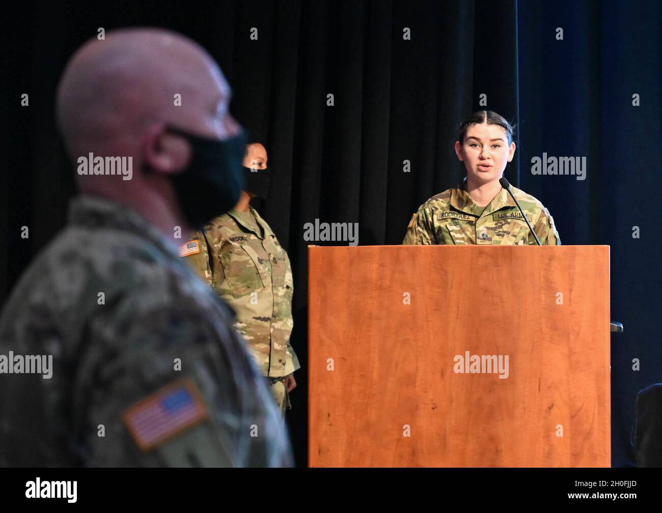 A member of the Band sings the National Anthem while members of the ...