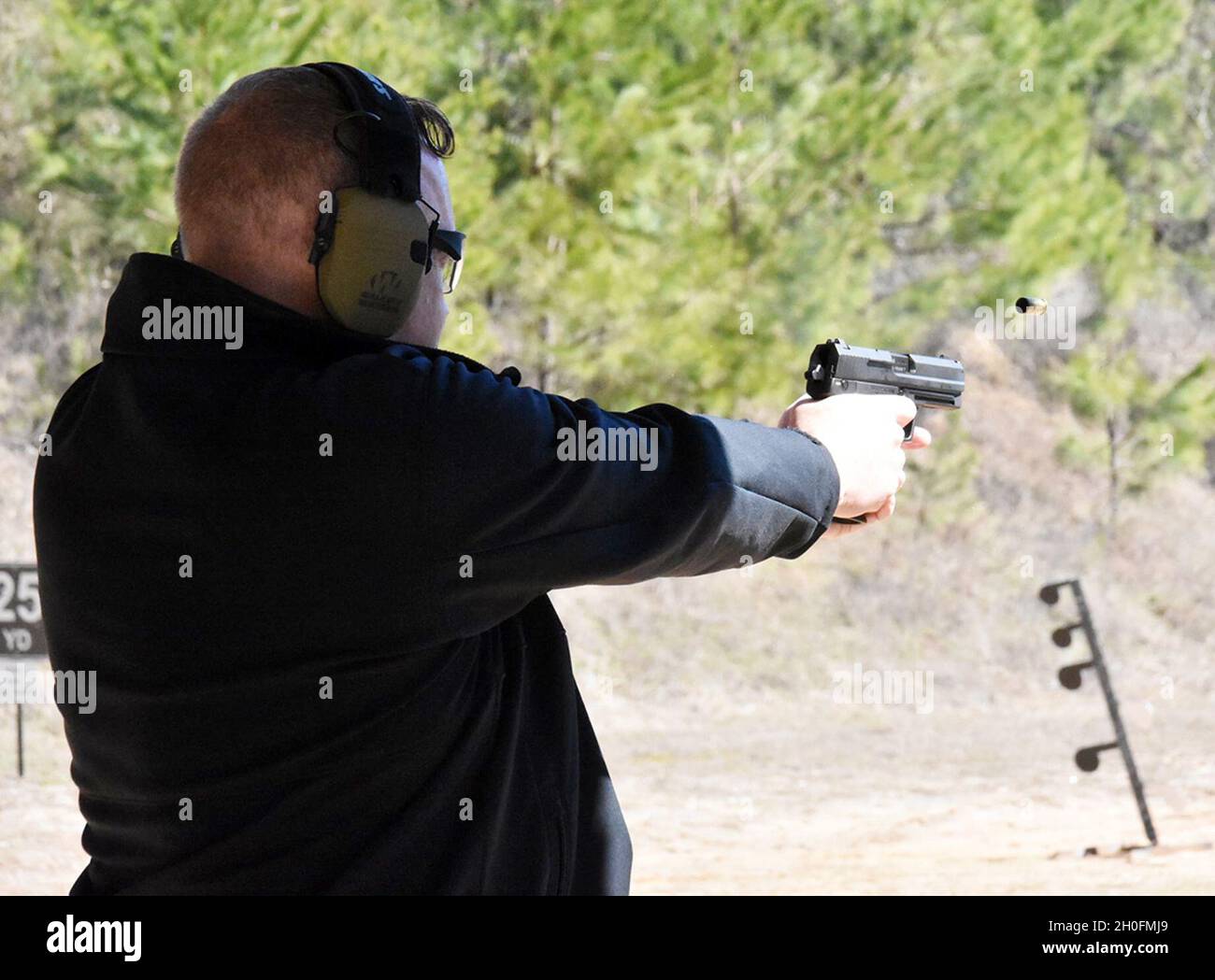 Col. Ryan Roseberry, Fort Polk garrison commander, fires his pistol ...