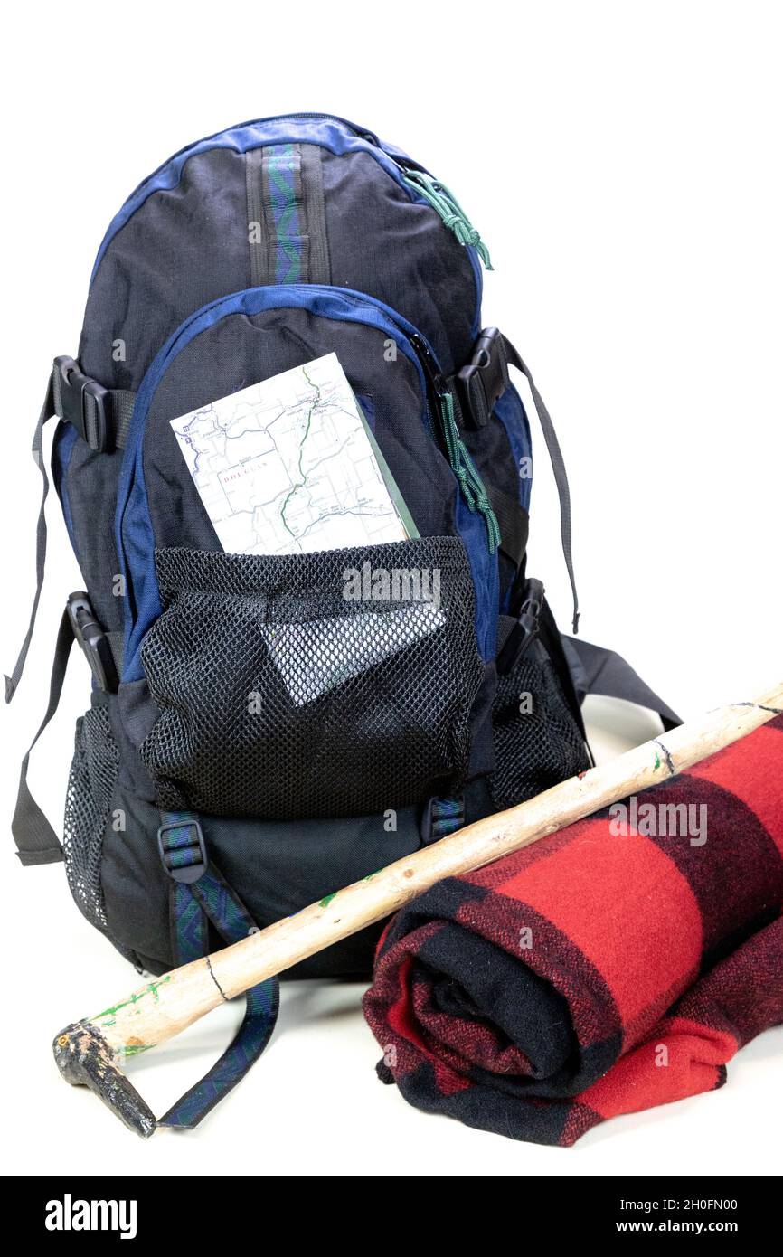 Backpack with map and walking stick Stock Photo - Alamy