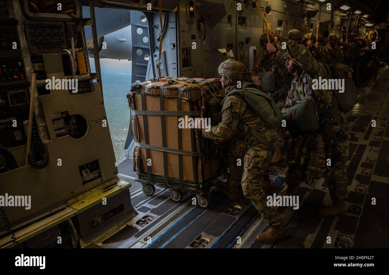 U.S. Soldiers with the 82nd Airborne Division push a Caster Assisted A ...