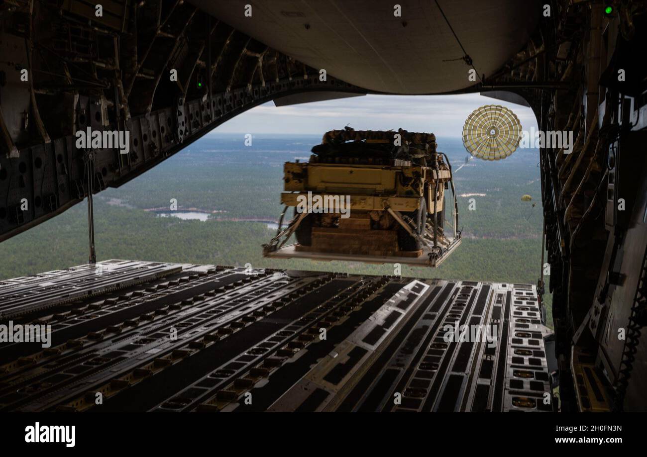 A Humvee is airdropped from a C-17 Globemaster III, assigned to the ...