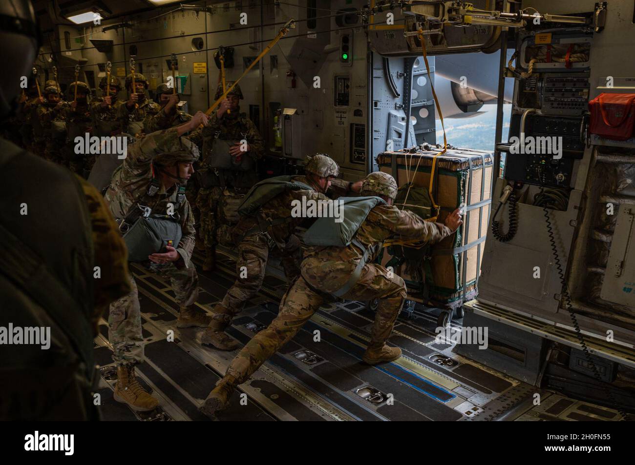 U.S. Soldiers with the 82nd Airborne Division push a Caster Assisted A ...