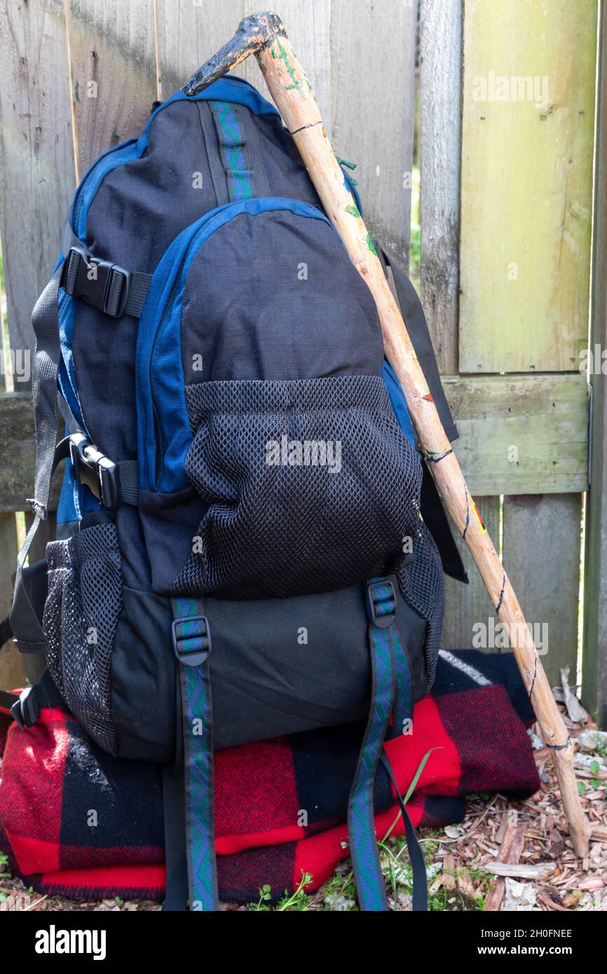 Backpack with blanket and walking stick Stock Photo - Alamy