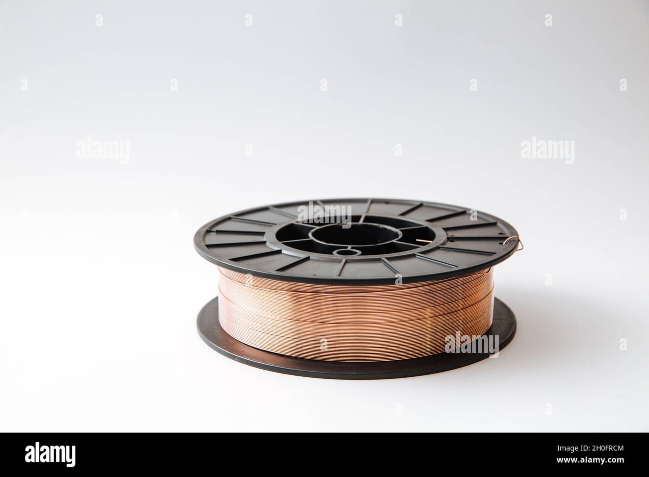 Welding wire spool on a white background. Copy space Stock Photo - Alamy