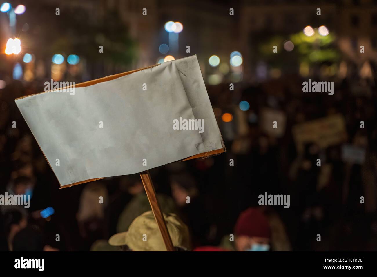 A white blank banner or card board during protest held by people in the ...
