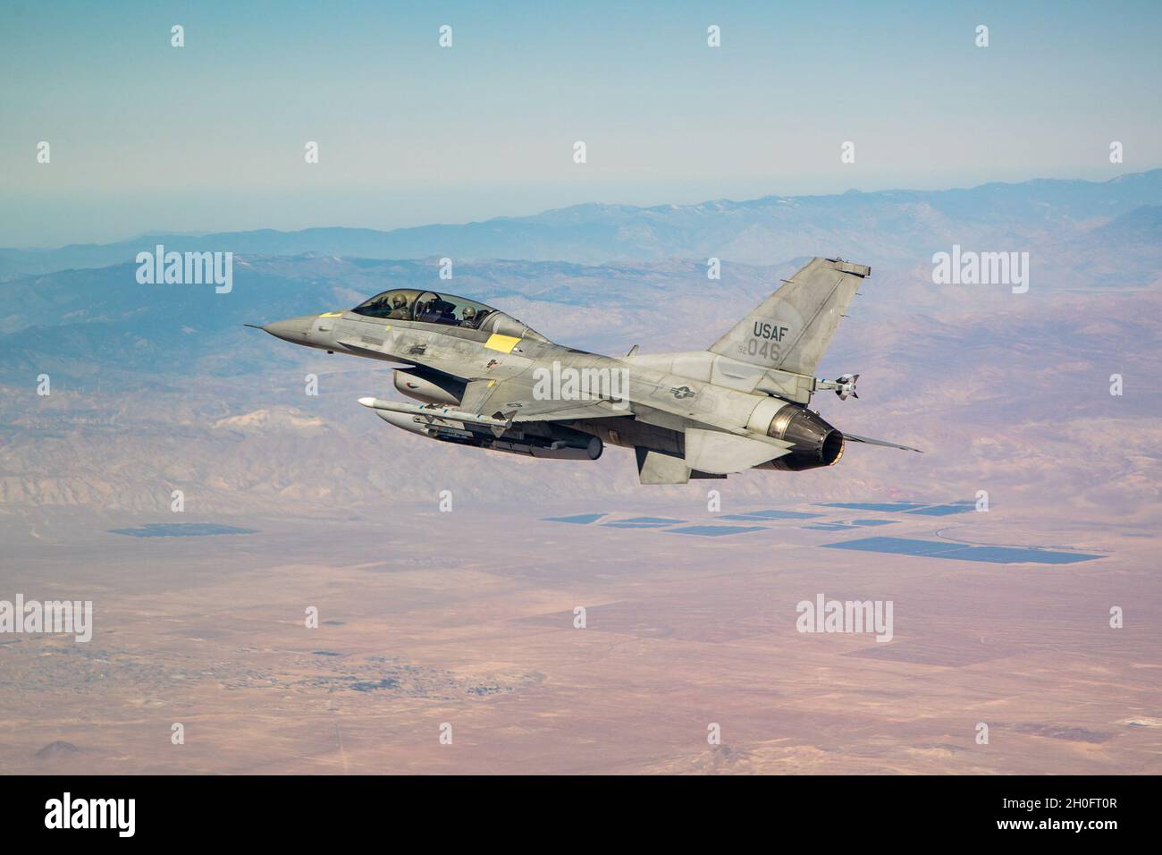 An F-16 assigned to the 416th Flight Test Squadron flies into position ...