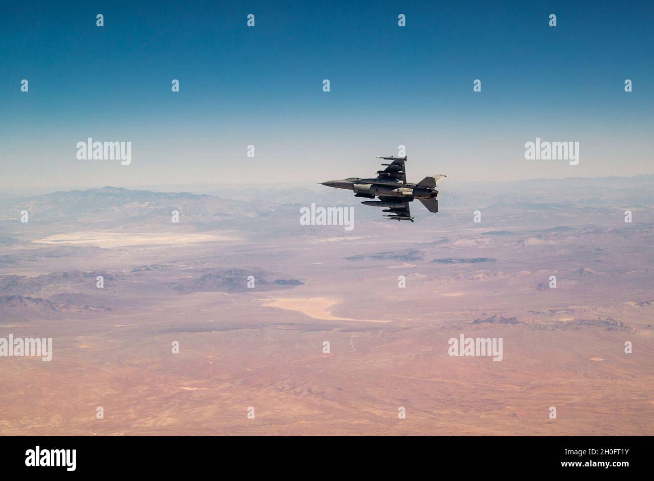 An F-16 assigned to the 416th Flight Test Squadron flies into position ...