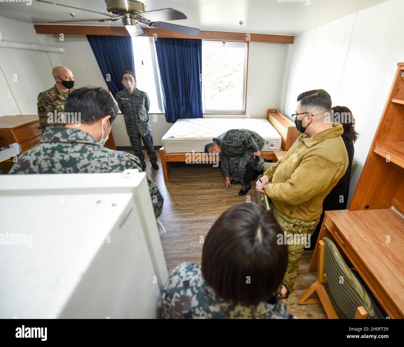U.S. and Japanese Airmen stand in a dormitory room on the 35th Fighter ...