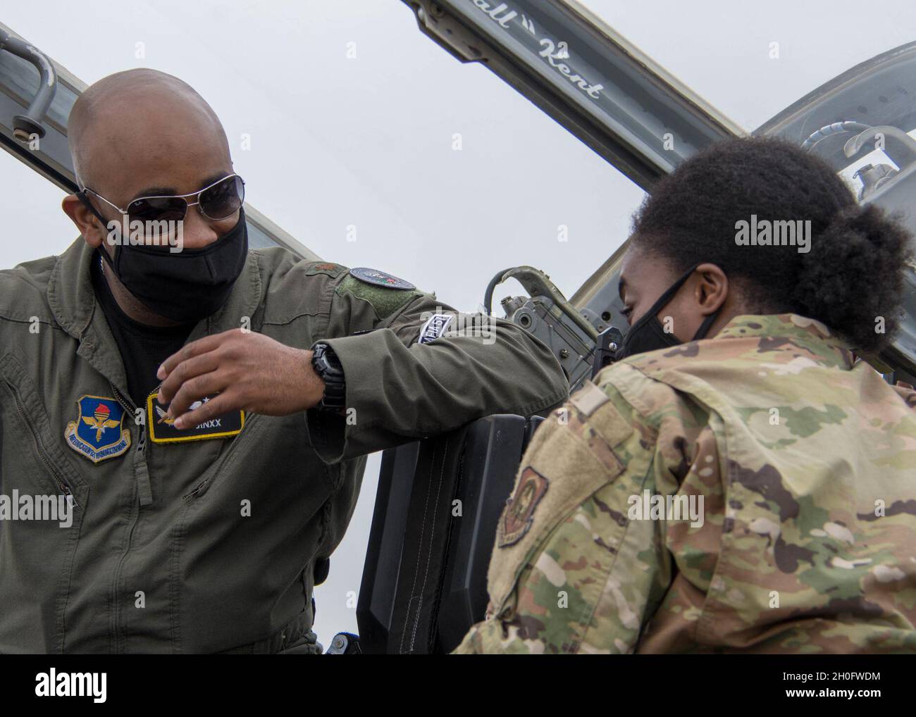 Major Dean Hall, from Joint Base San Antonio, shows a ROTC Cadet from ...