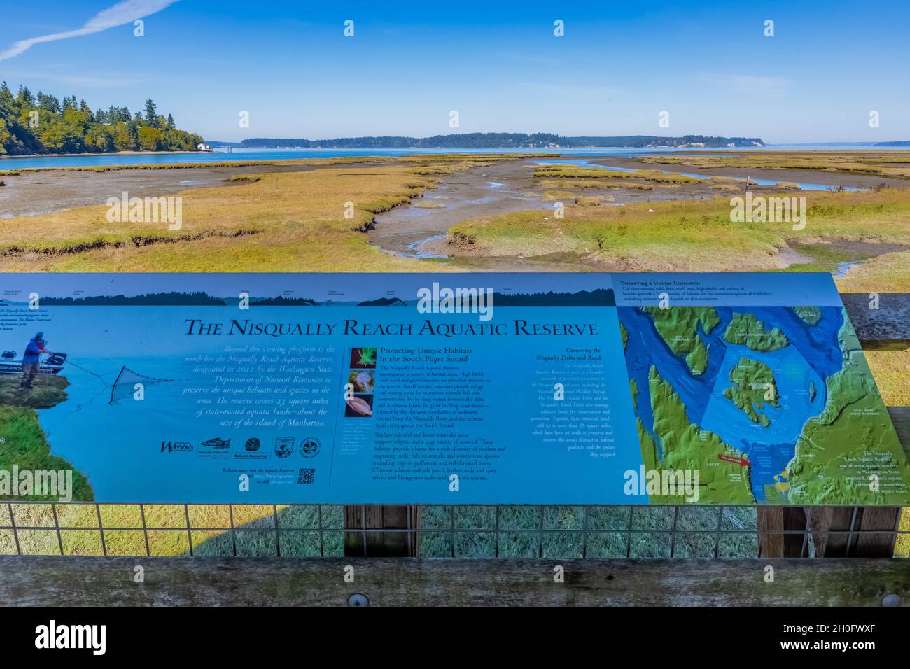 Map and interpretive sign on the boardwalk over the estuary and tidally ...