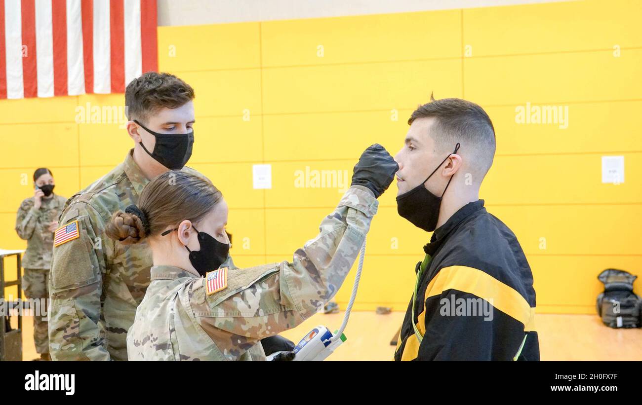A soldier has his temperature checked Feb. 28 at Katterbach Fitness ...