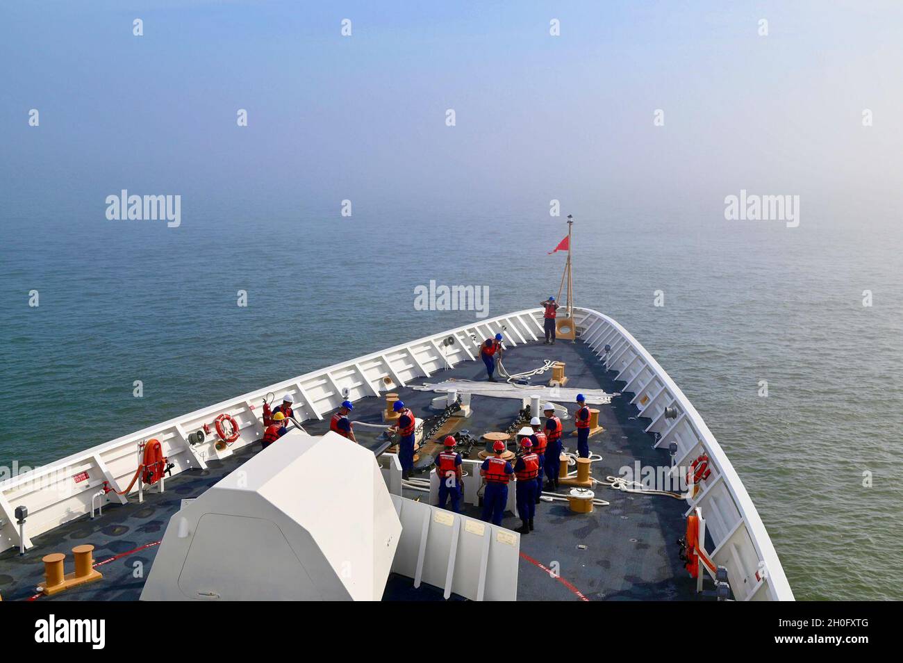 USCGC Stone (WMSL 758) crew stows lines on the Stone's forward weather ...