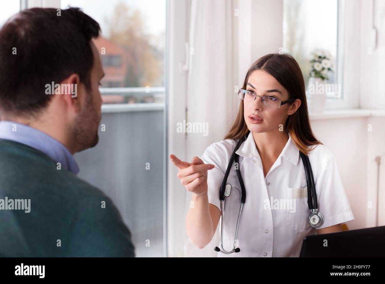 Man explaining something to a woman hi-res stock photography and images ...