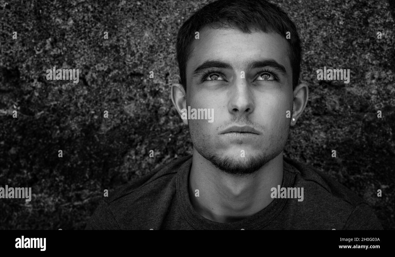 Grayscale shot of a male looking up Stock Photo - Alamy