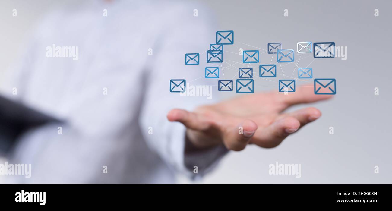 3D rendering of email icons floating on a man's hand against a blurred ...