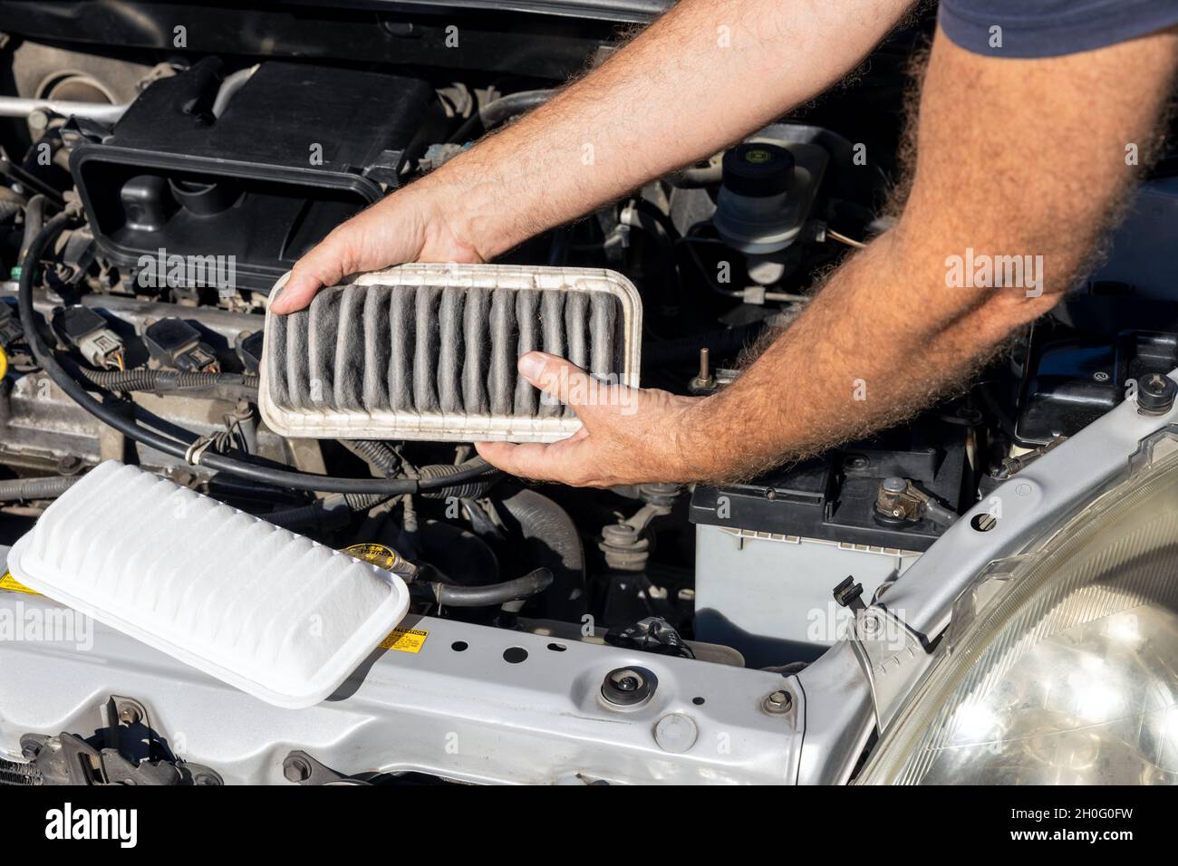 Replacing the dirty internal combustion air filter for a car Stock ...