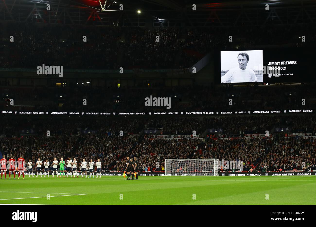 London, England, 12th October 2021. Players and fans observe a minutes ...