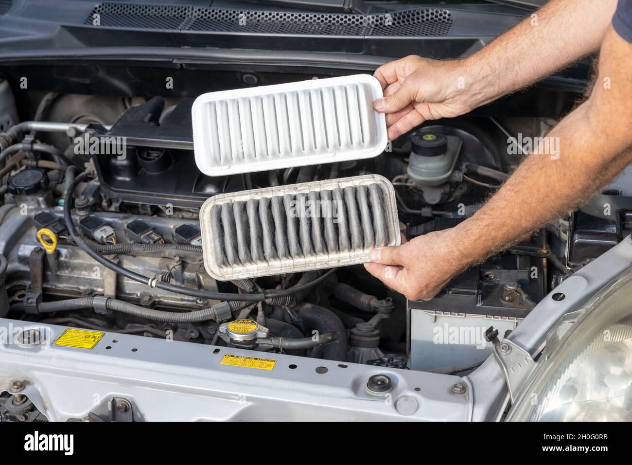 Replacing the dirty internal combustion air filter for a car Stock ...