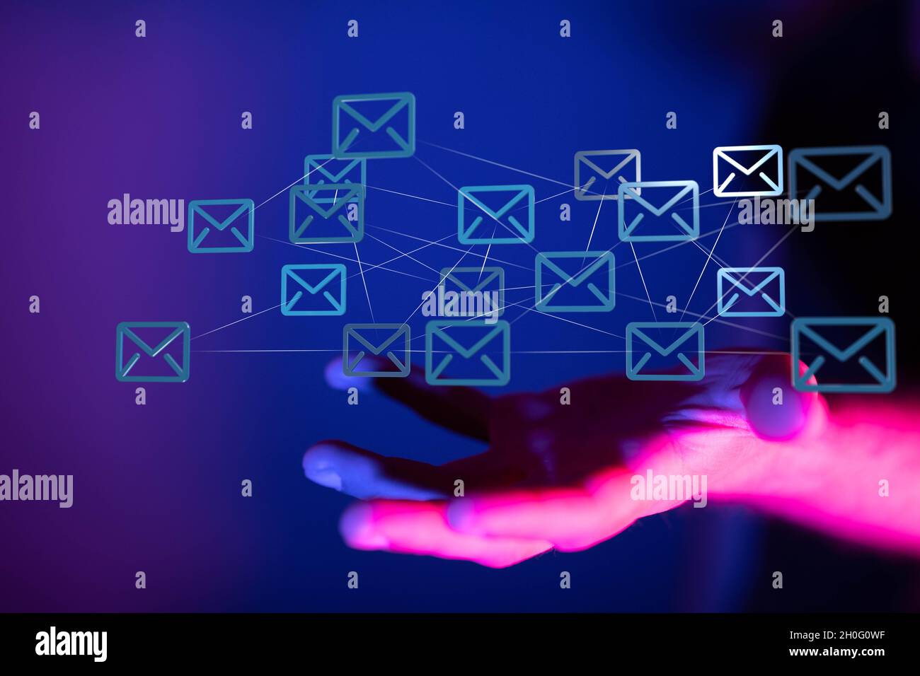 3D rendering of email icons floating on a man's hand against a dark ...