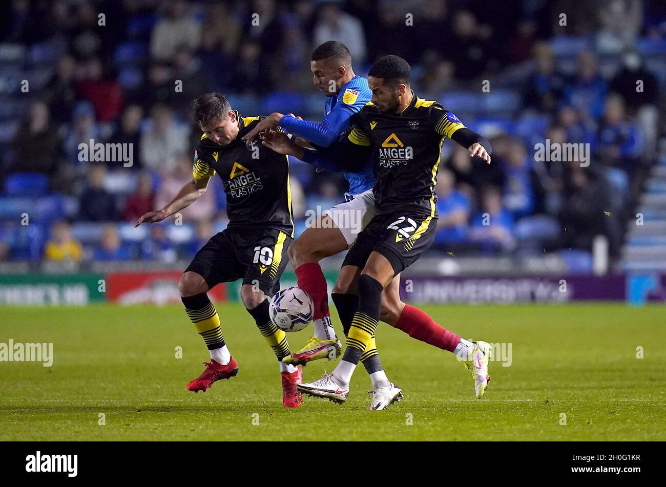 Portsmouth's Gassan Ahadme battles for the ball with Sutton United's ...