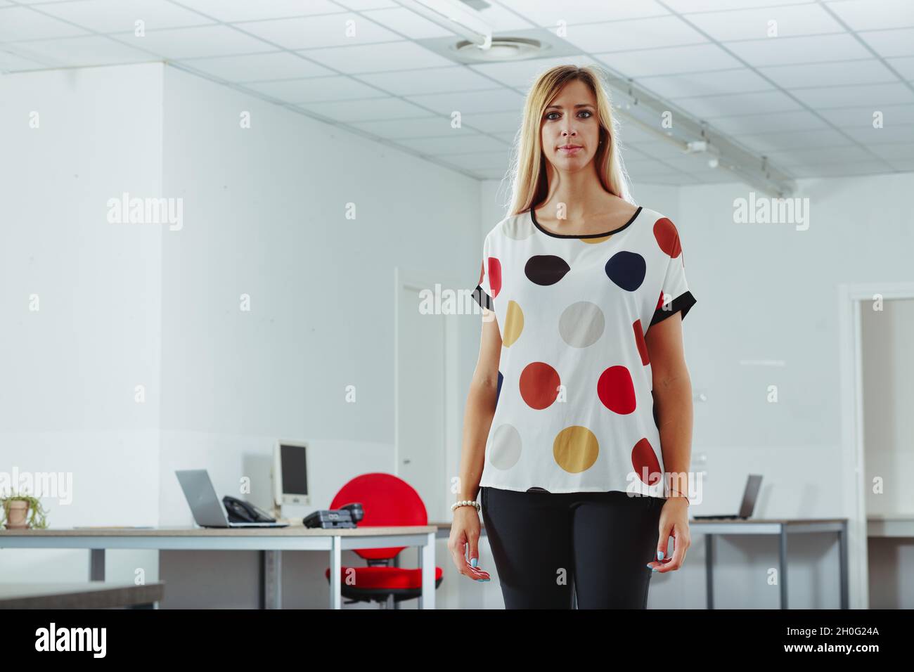 Determined intense businesswoman standing staring down at camera in a ...