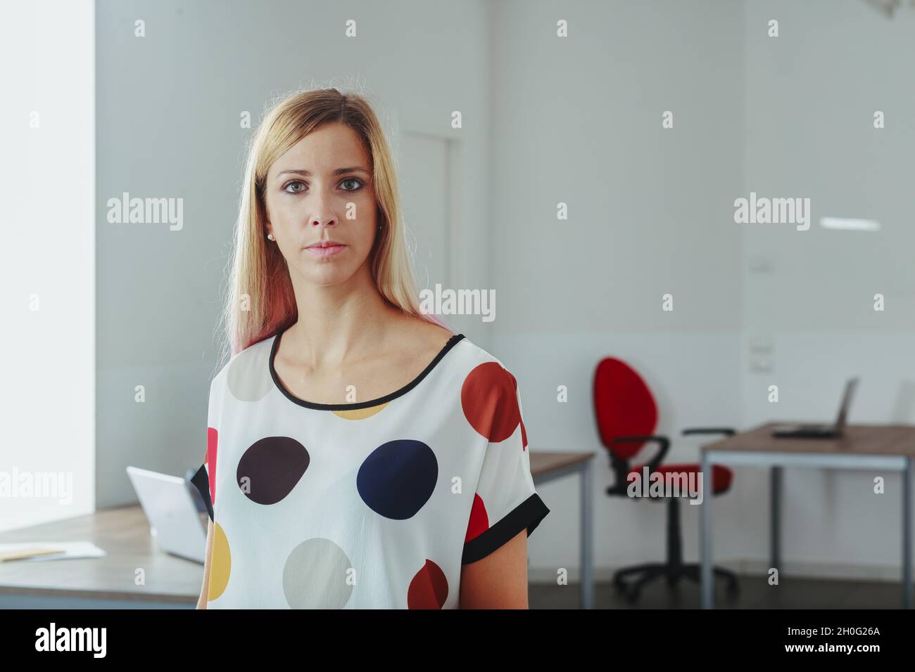 Attractive middle-aged businesswoman staring at the camera with a ...
