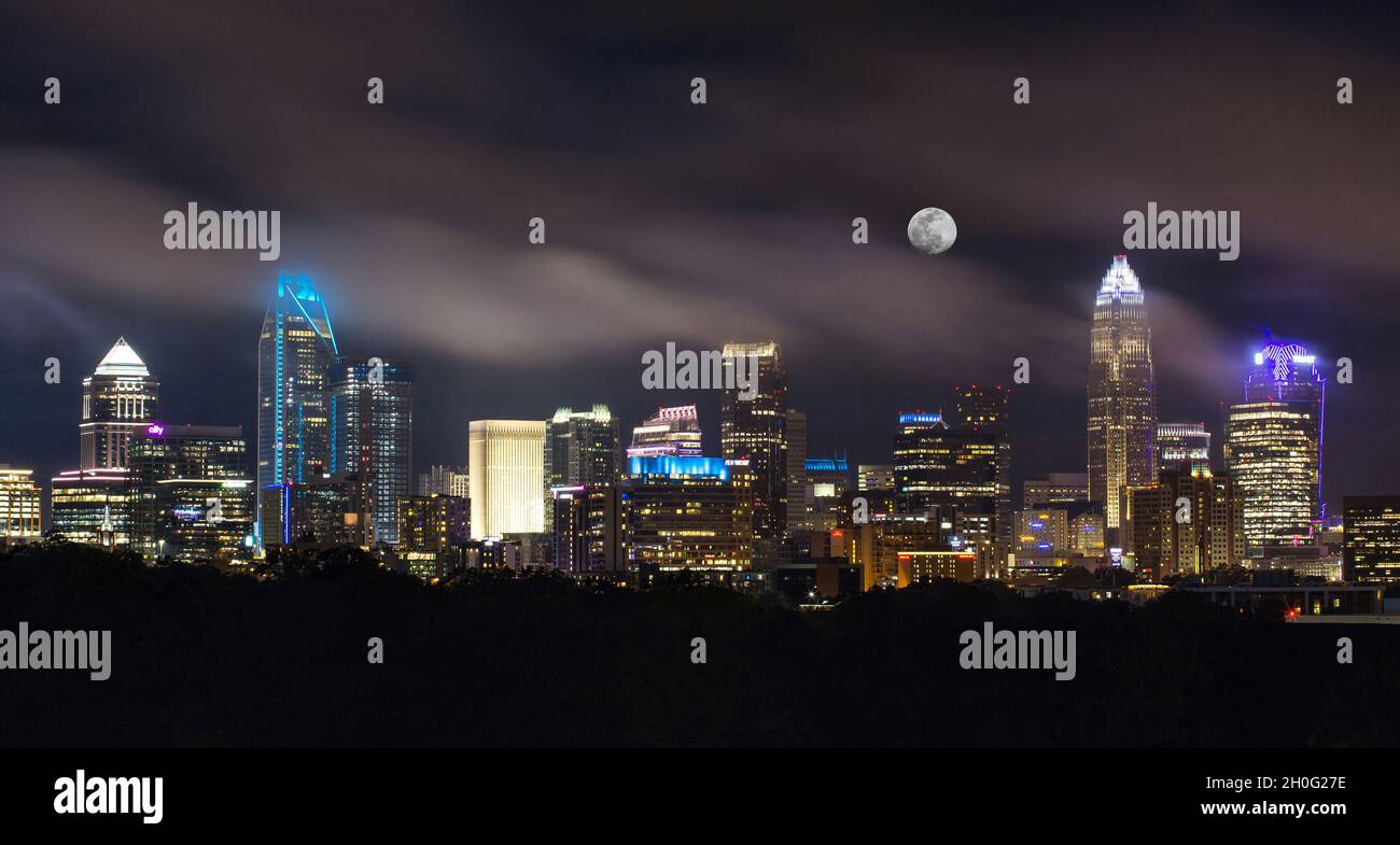 Low clouds are illuminated by city lights as they pass over the ...