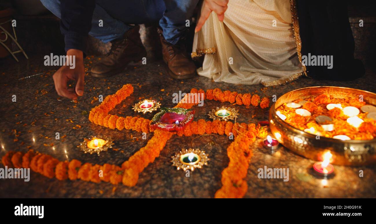 South Asian young people from India doing a ritual with candles on the ...