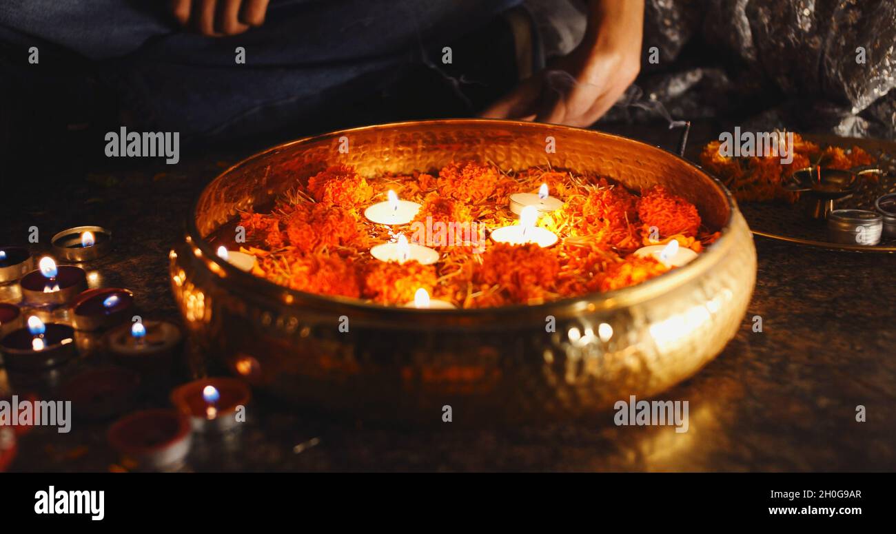 South Asian young people from India doing a ritual with candles on the ...