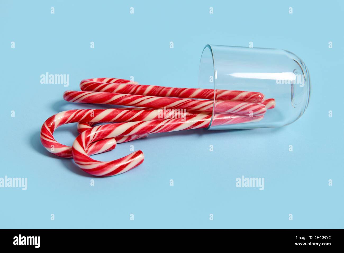 An inverted glass lying on a blue background with New Year's Christmas ...