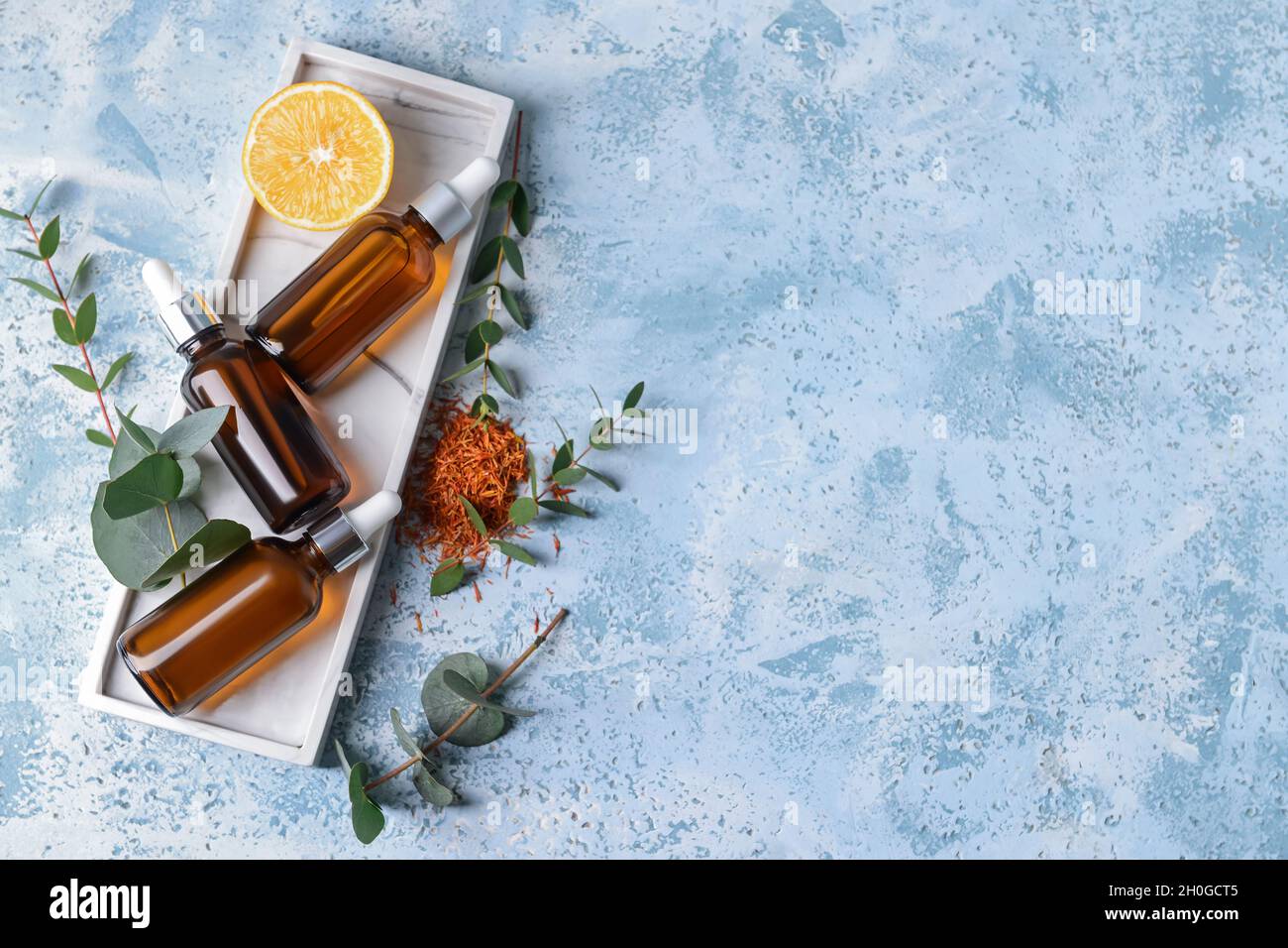 Bottles of essential oils on color background Stock Photo - Alamy