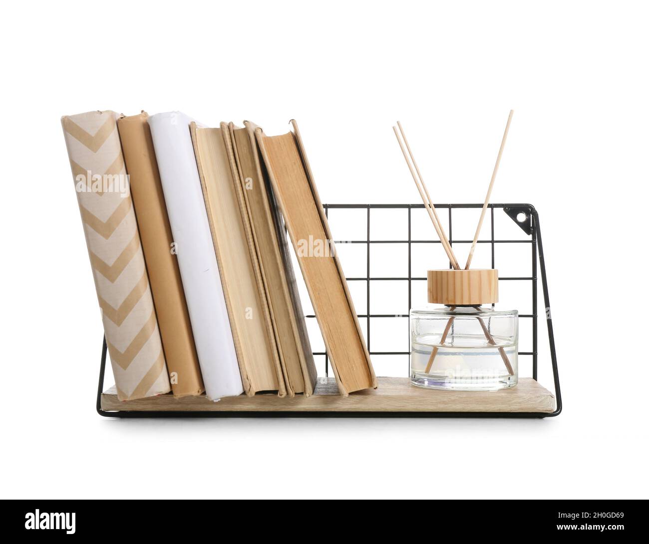 Hanging book shelf with reed diffuser on white background Stock Photo ...