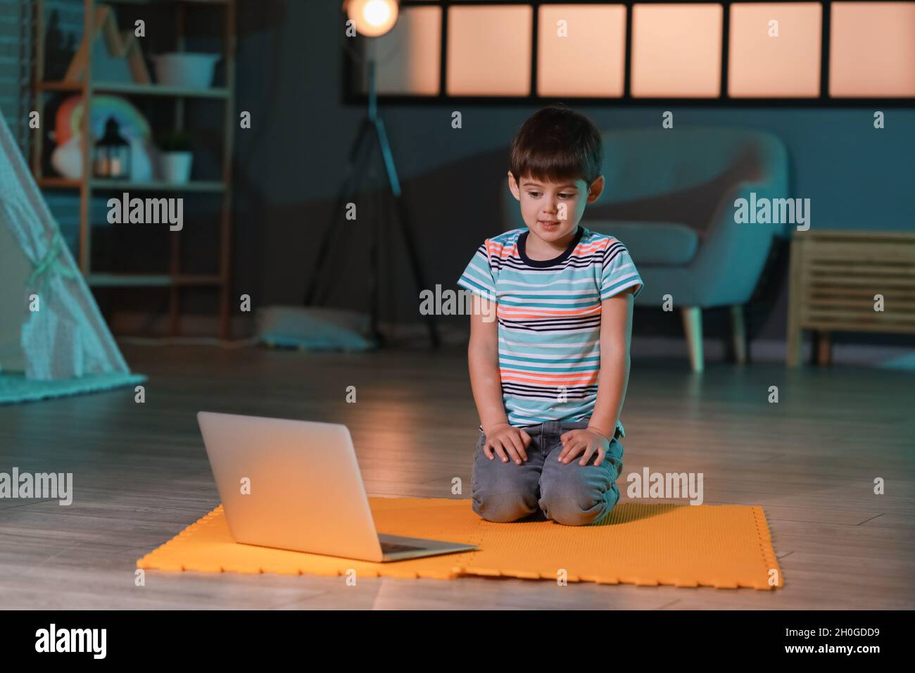 Little boy watching cartoons on laptop at home late in evening Stock ...