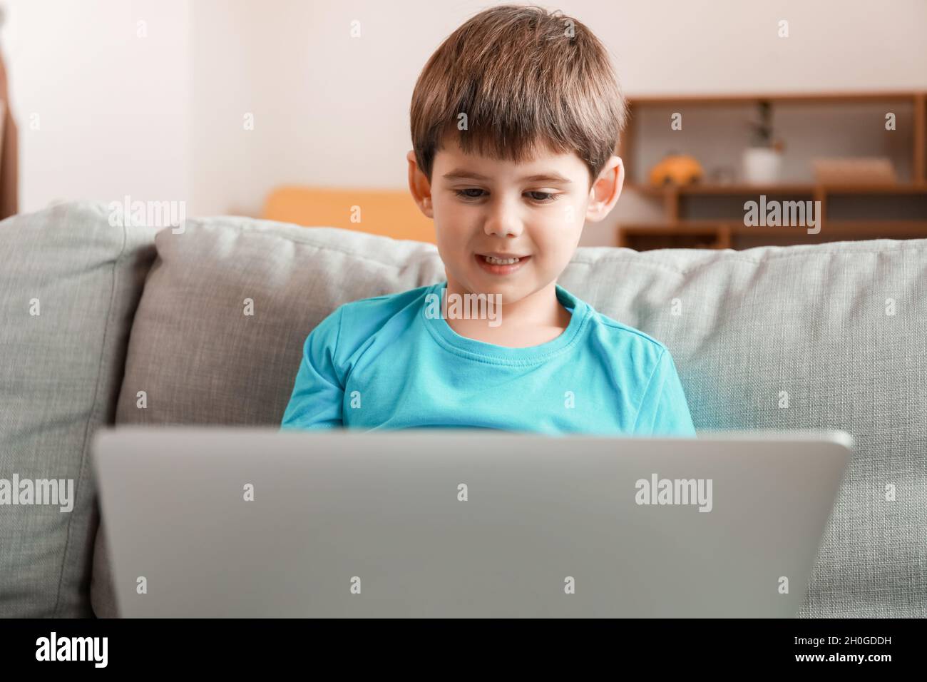 Little boy watching cartoons on laptop at home Stock Photo - Alamy