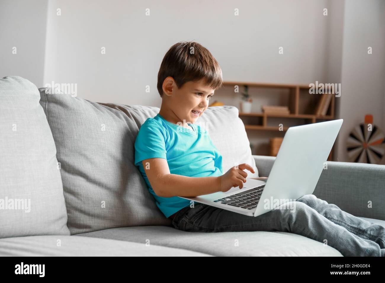 Little boy watching cartoons on laptop at home Stock Photo - Alamy