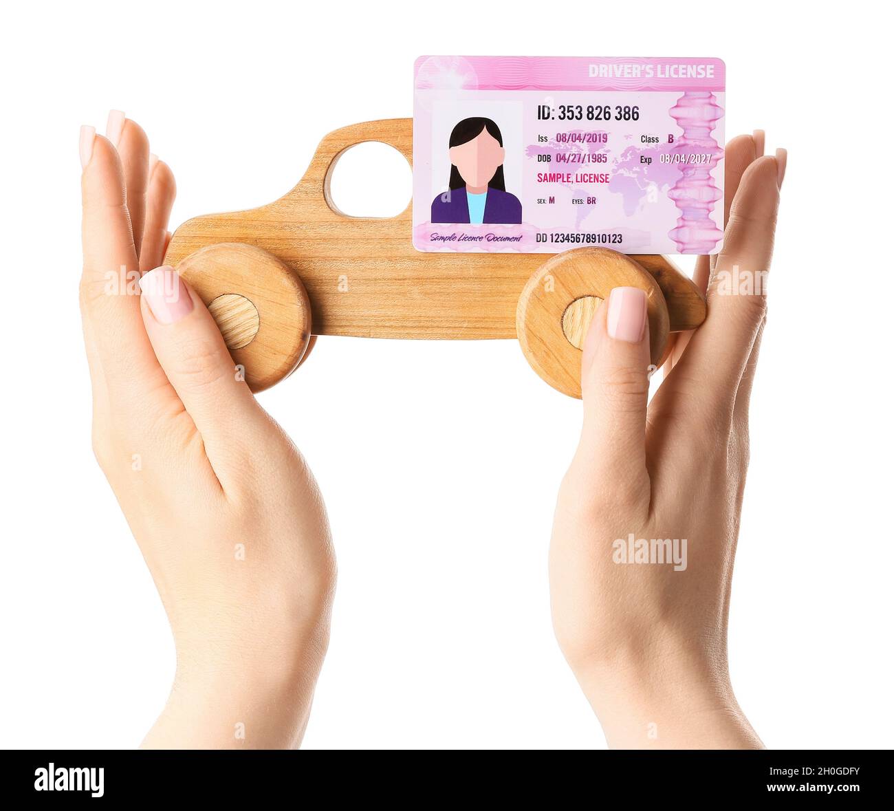 Woman with wooden car and driving license on white background Stock ...