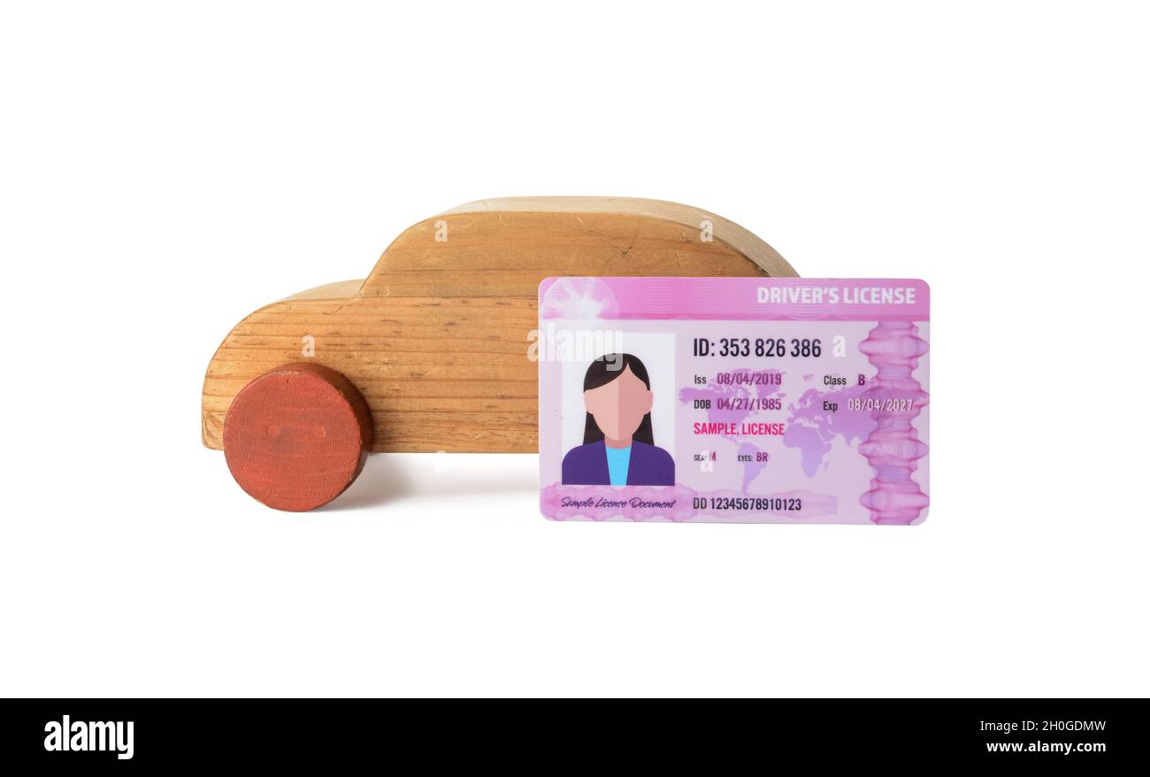 Wooden car with driving license on white background Stock Photo - Alamy