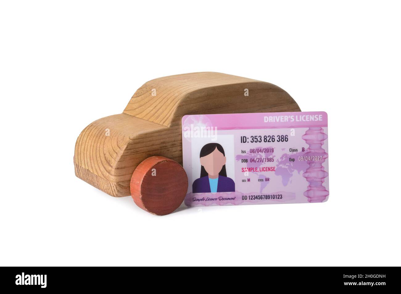 Wooden car with driving license on white background Stock Photo - Alamy