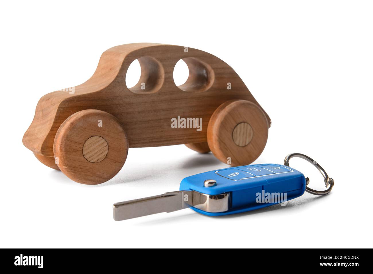 Wooden car and key on white background Stock Photo - Alamy