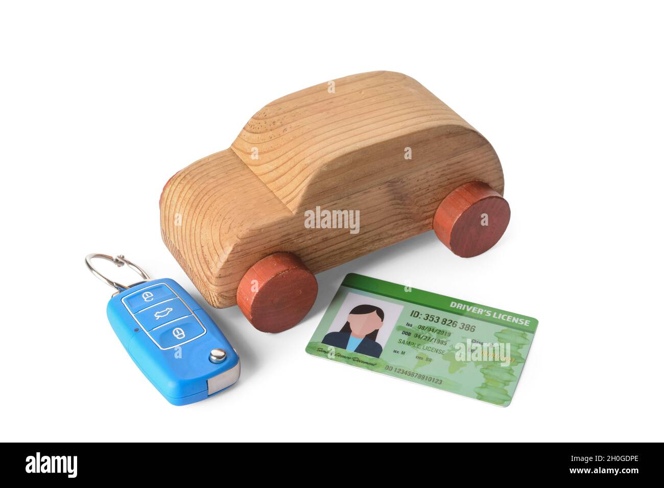 Wooden car, key and driving license on white background Stock Photo - Alamy