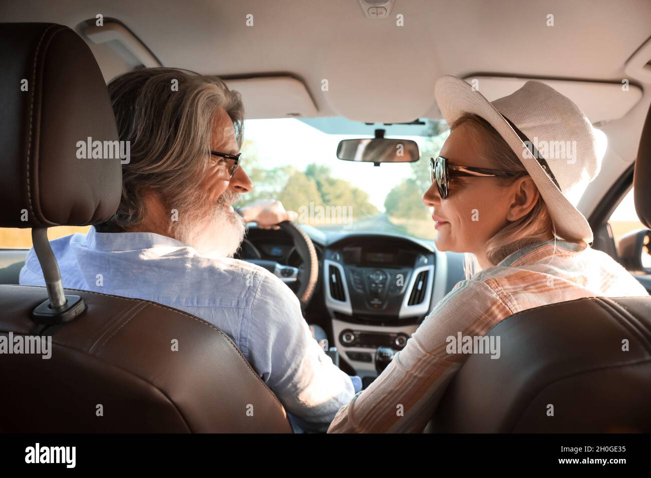 Happy mature couple traveling by car Stock Photo - Alamy