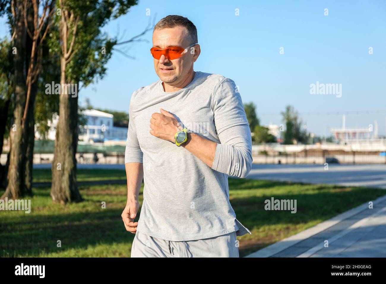 Sporty mature man in sunglasses running outdoors Stock Photo - Alamy