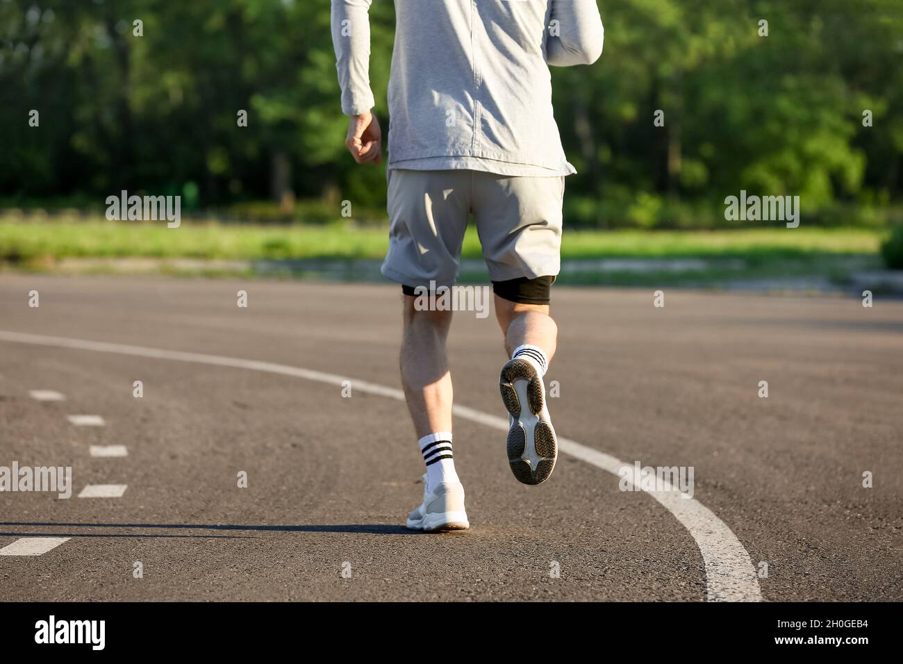 Sporty mature man running on road Stock Photo - Alamy
