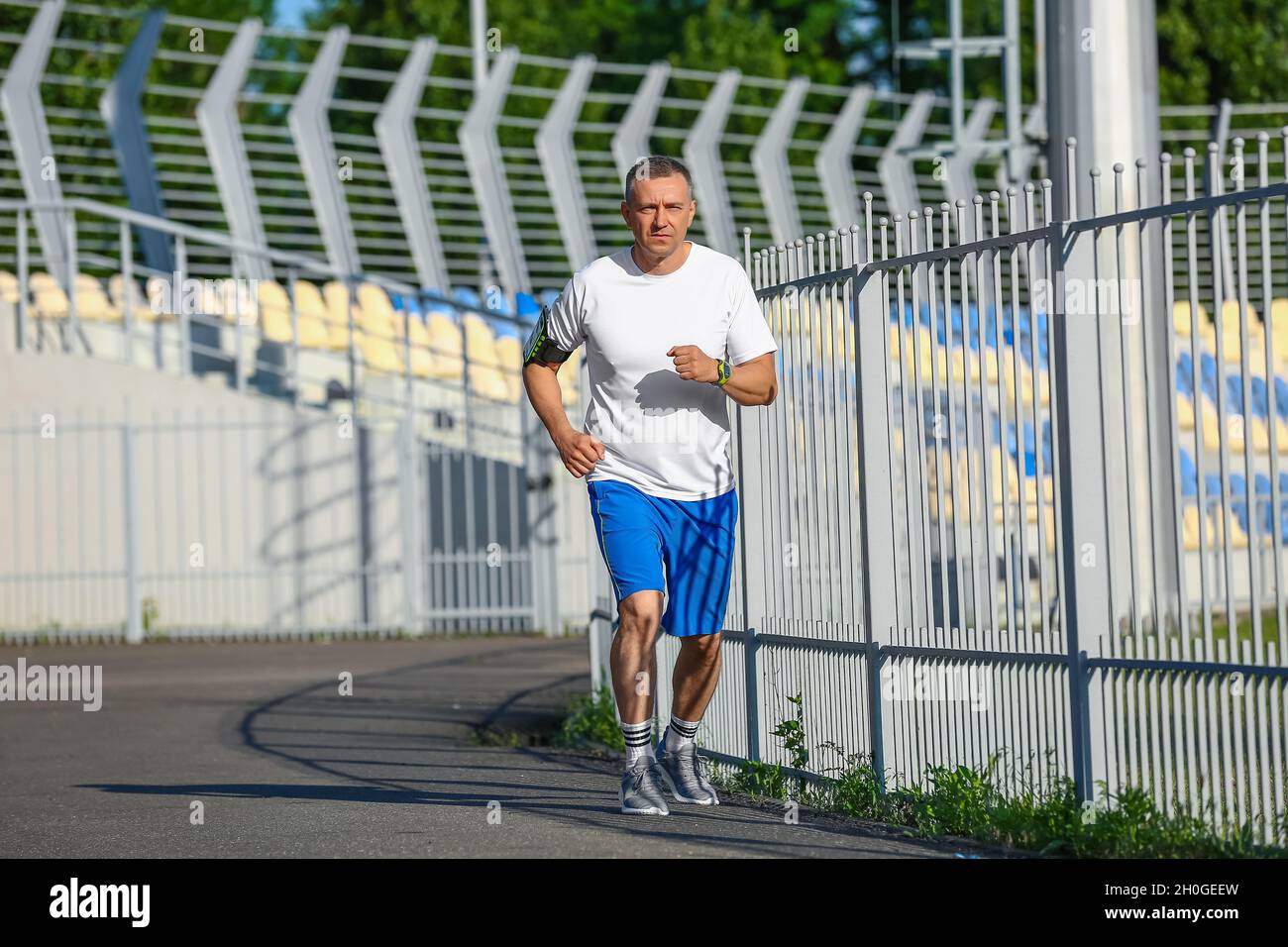 Sporty mature man running at stadium Stock Photo - Alamy