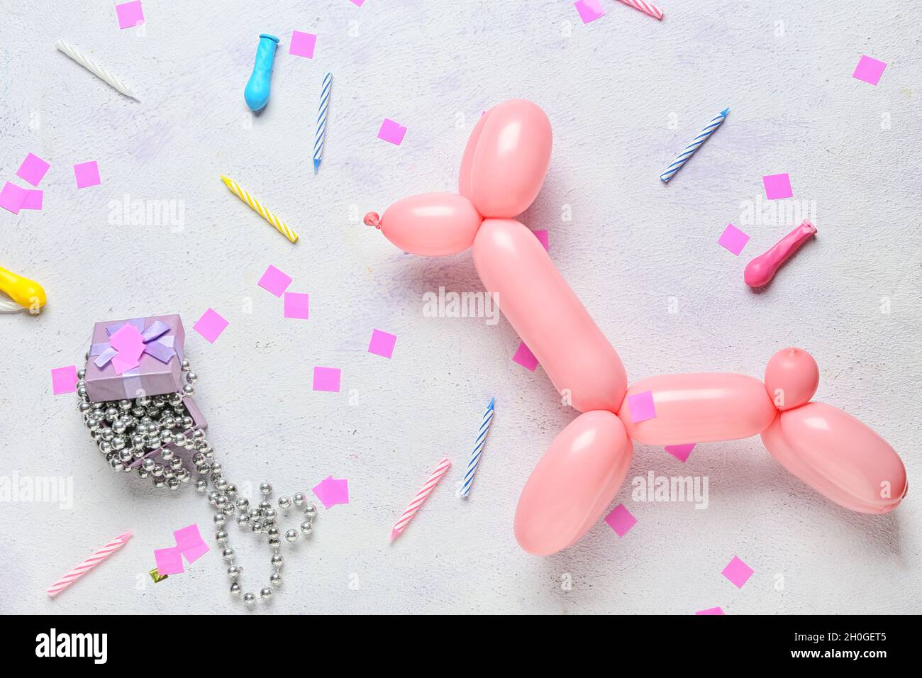 Pink dog shaped balloon with birthday candles on light background Stock ...