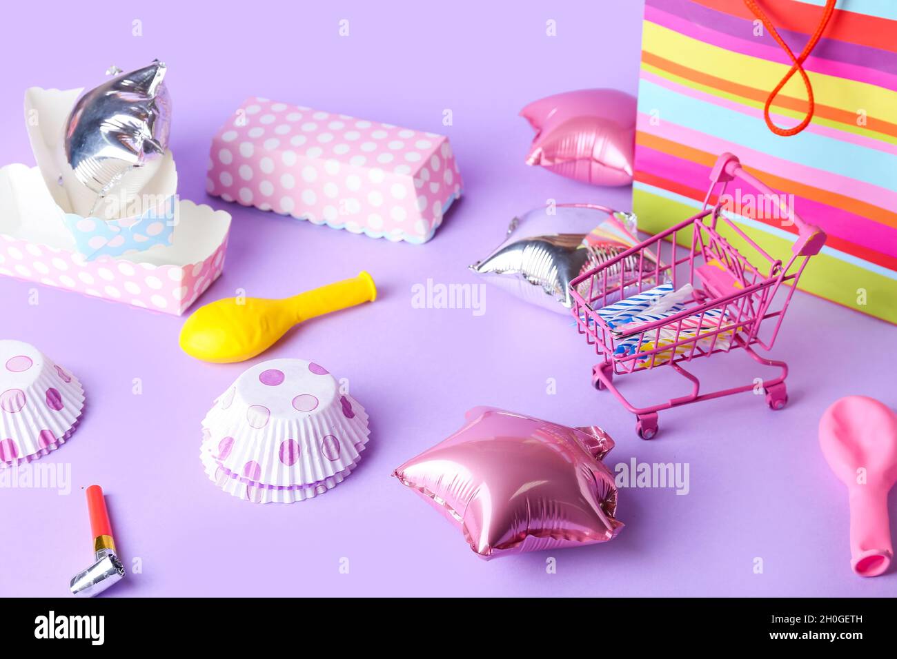 Composition with shopping cart, star shaped balloon and festive things ...