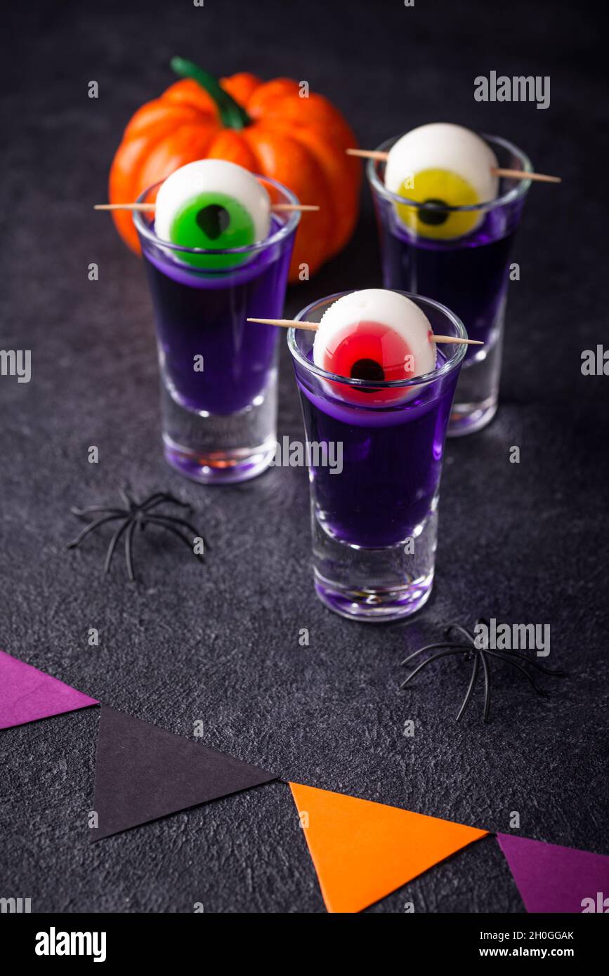 Halloween purple cocktail with eyes Stock Photo - Alamy